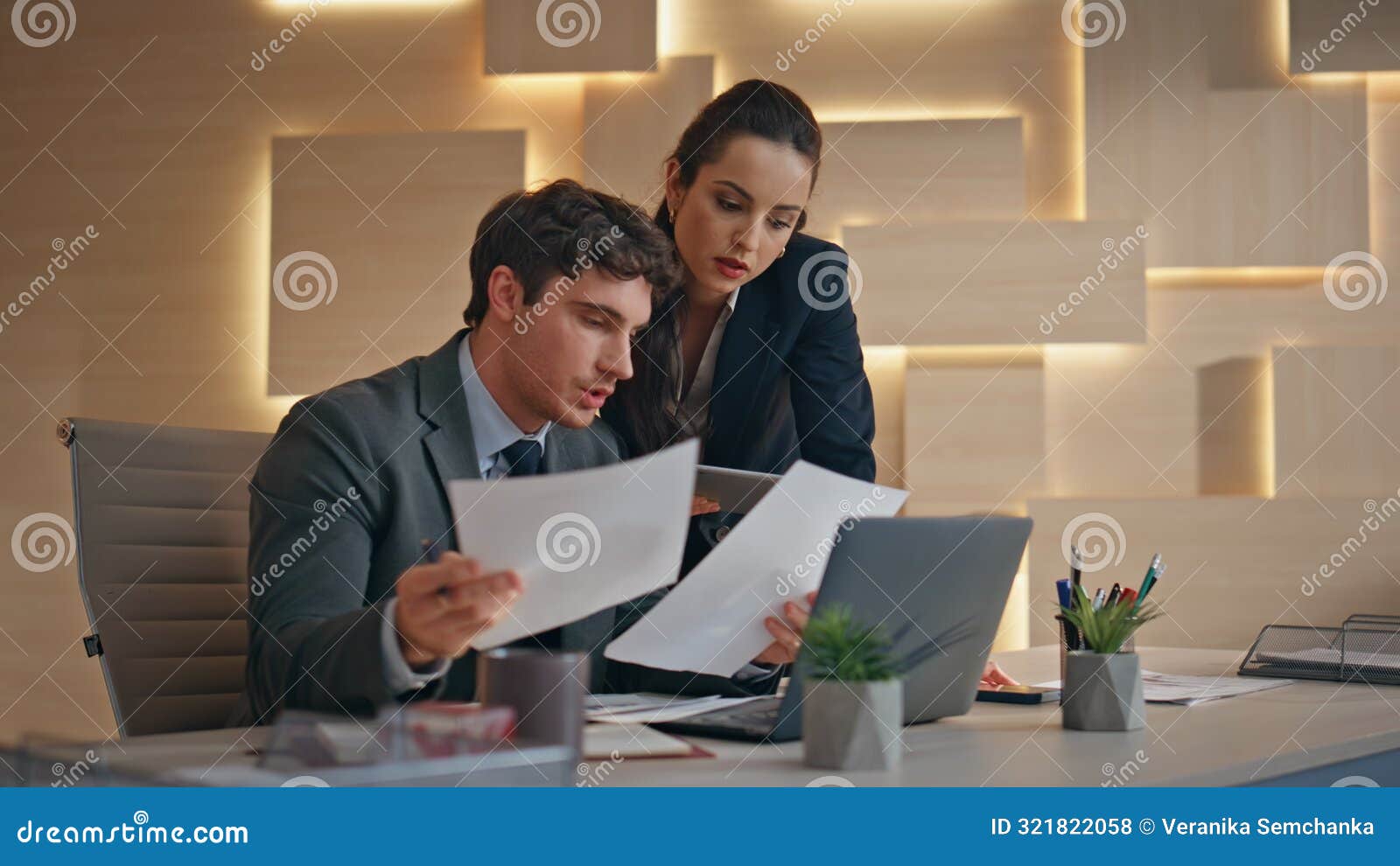 Office Team Watching Papers Working Together at Computer Workplace ...