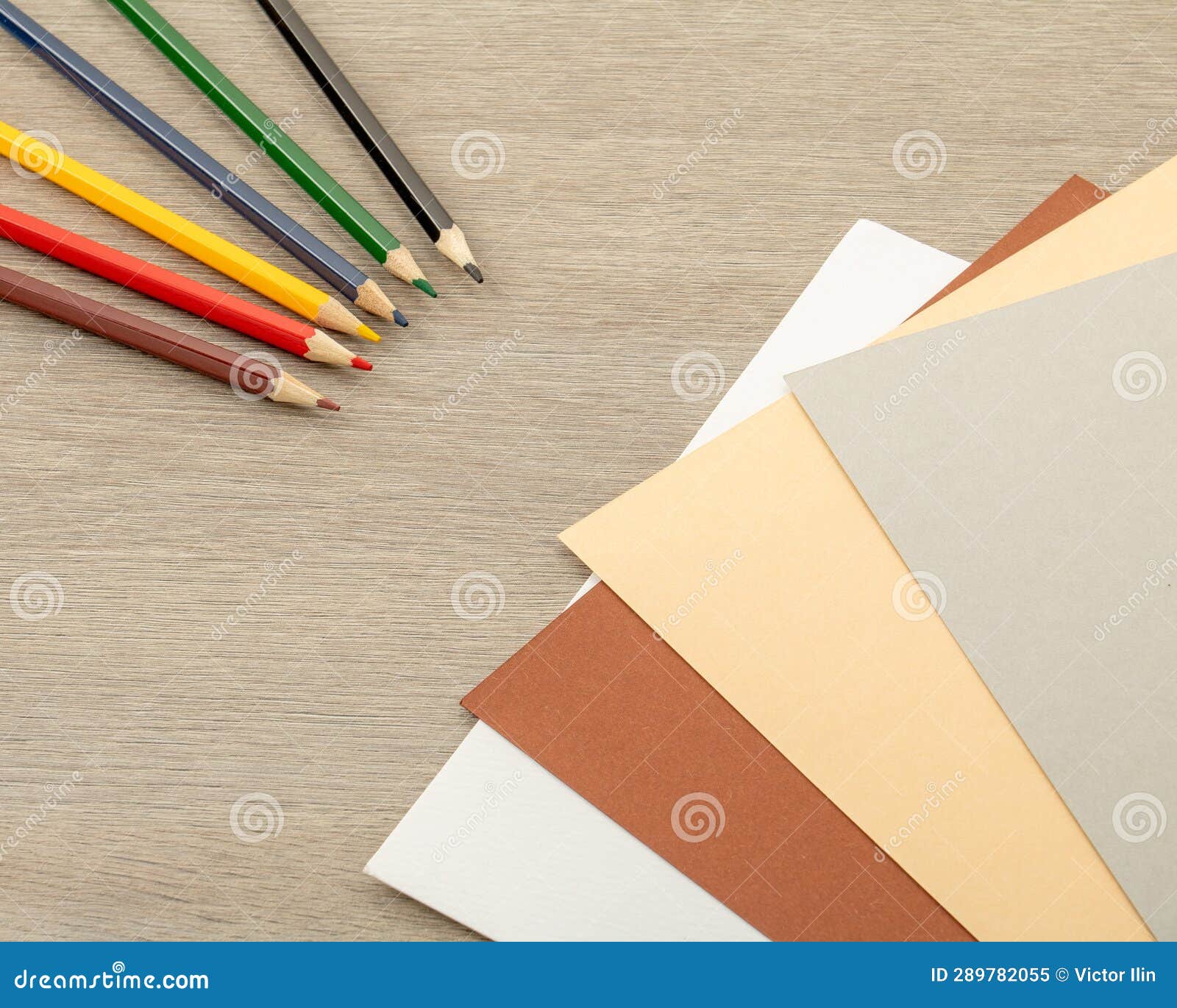 Office Theme. Multi-colored Pencils and Sheets of Colored Paper are ...