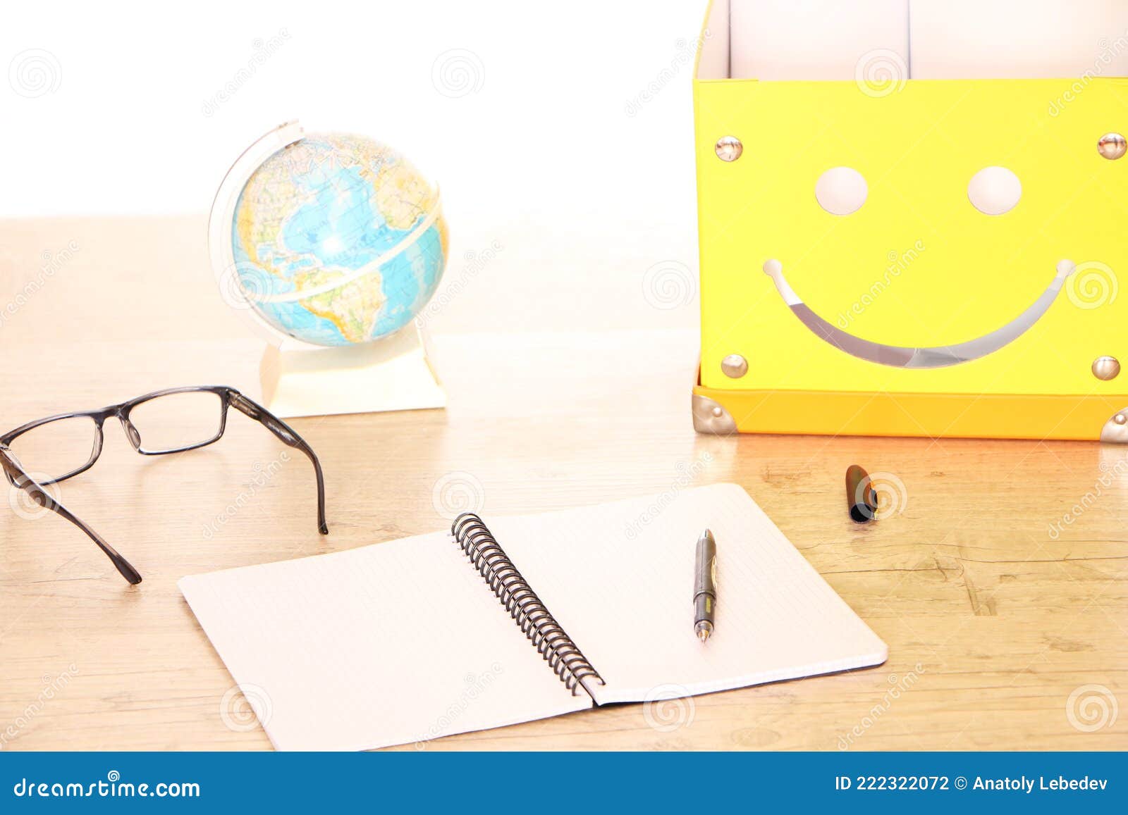 In the Office There is a Yellow Box with Documents and a Globe on the ...