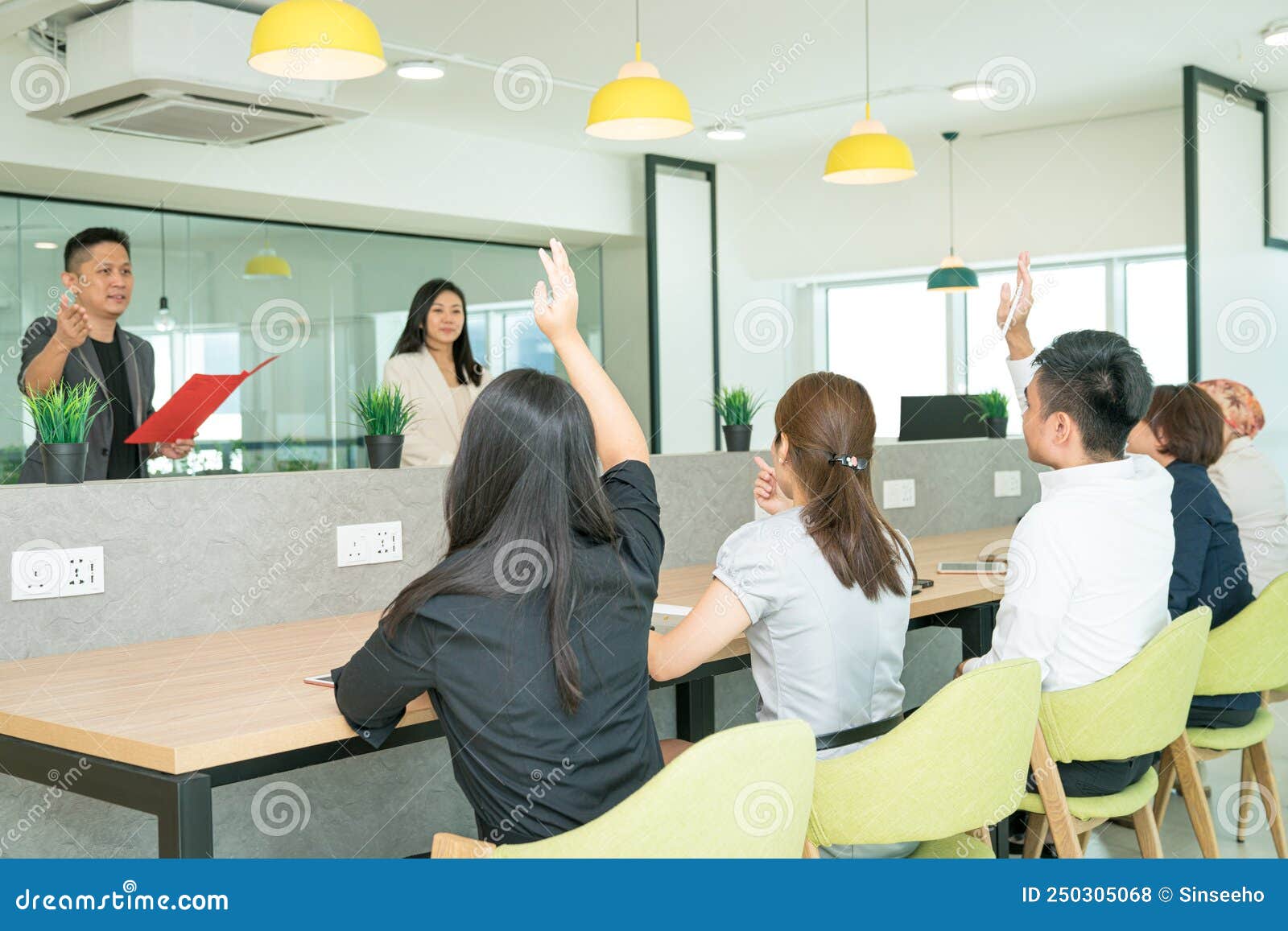 Office Training in Progress with Trainees Raising Hands To Ask ...