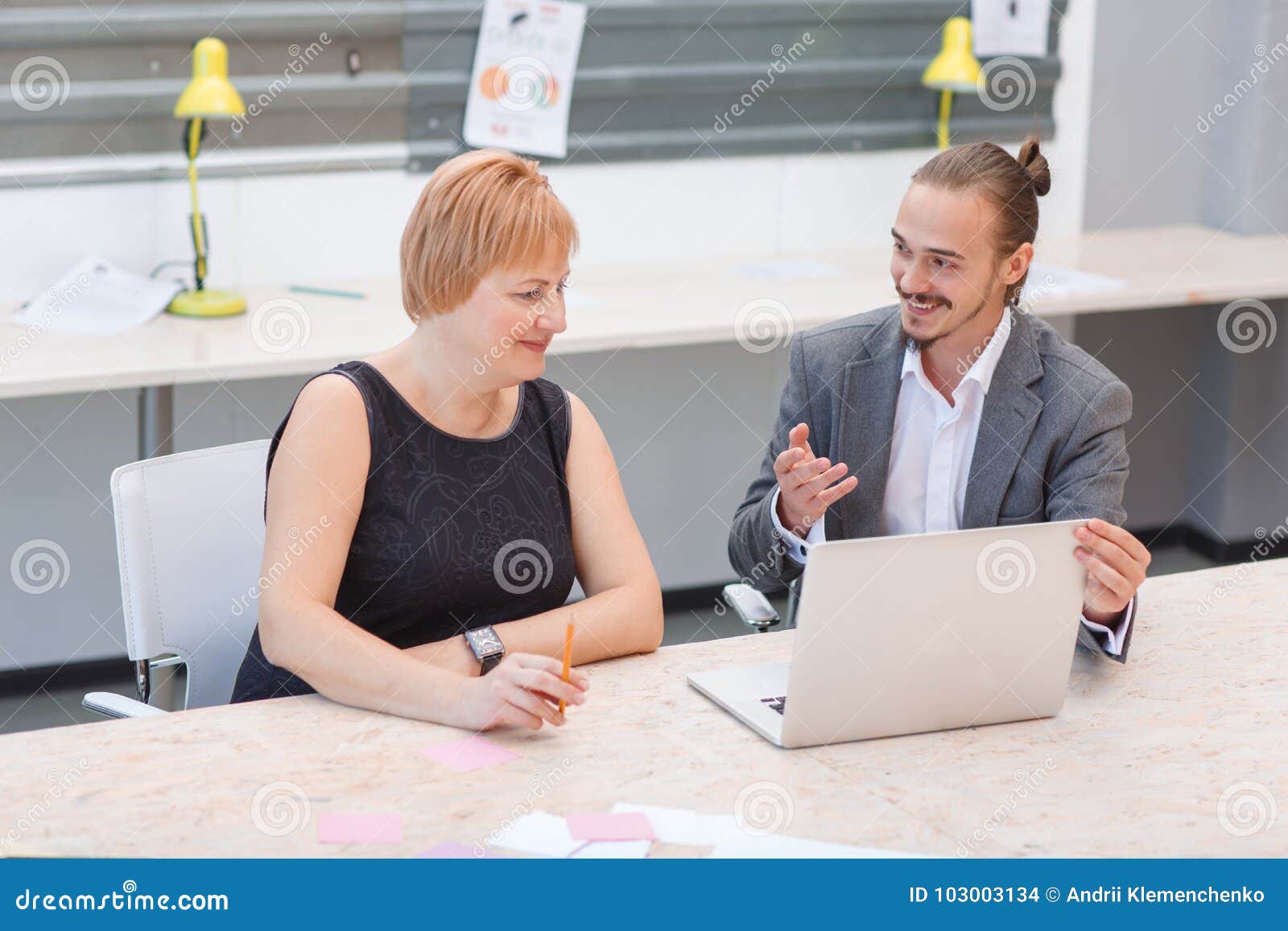 In the Office. Two Workers are Discussing Something while Sitting at ...