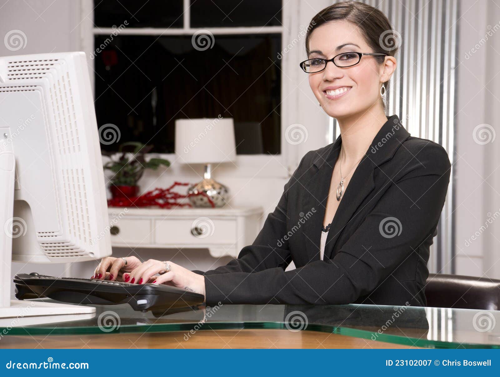 Office Worker Smiles while Entering Data Computer Stock Image - Image ...
