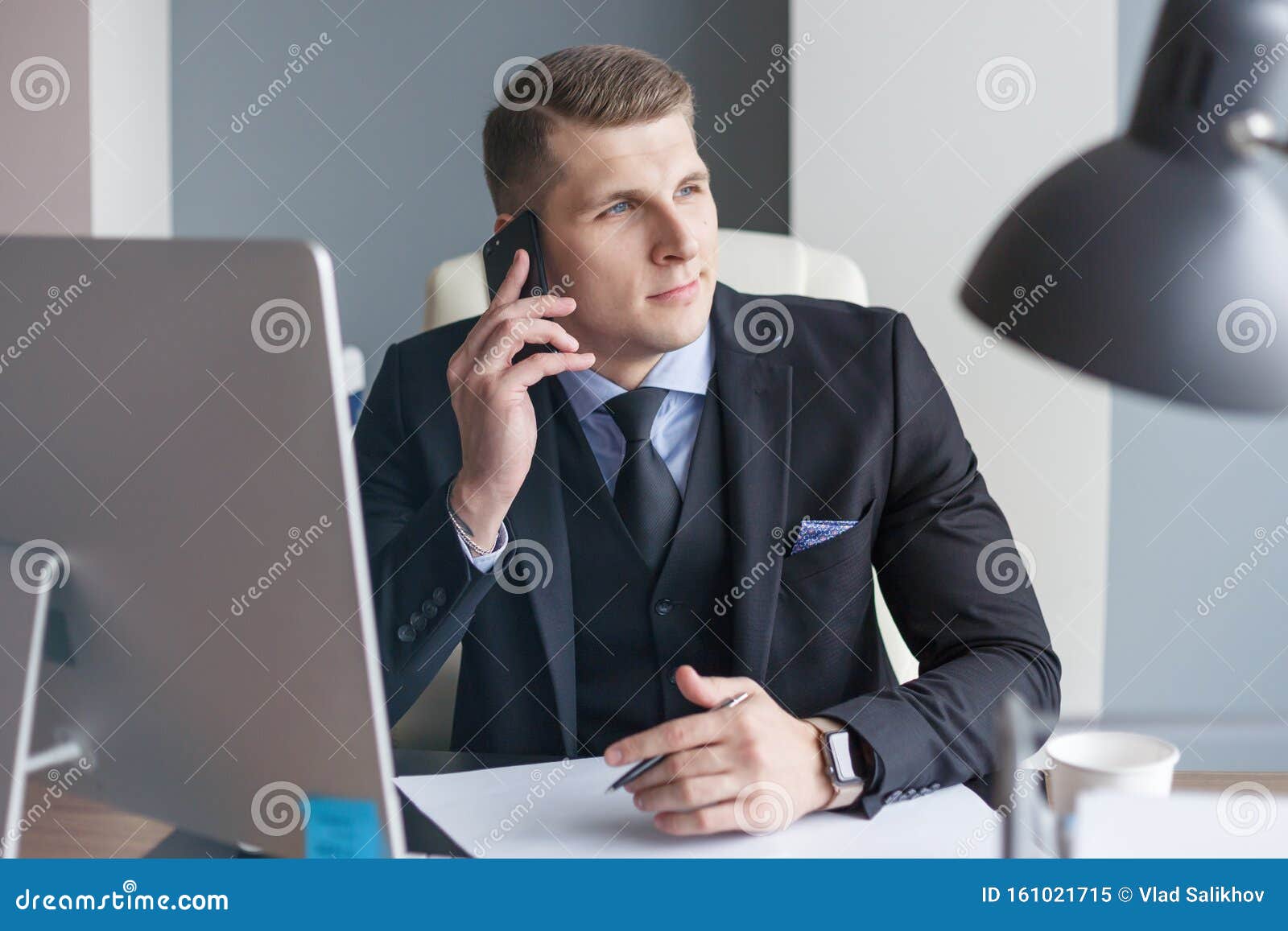 Office Worker Calling on Mobile Phone, Sitting at Desk Stock Image ...