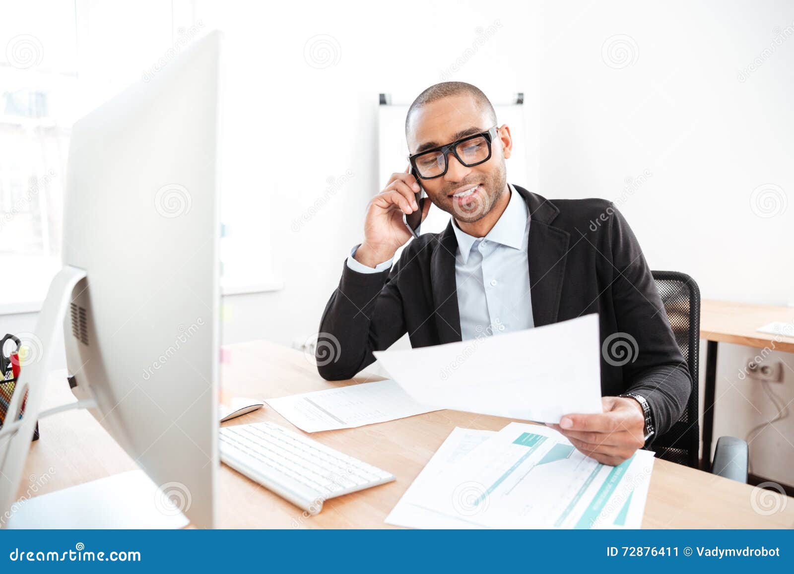 Office Worker Calling on the Phone and Reading Business Document Stock ...