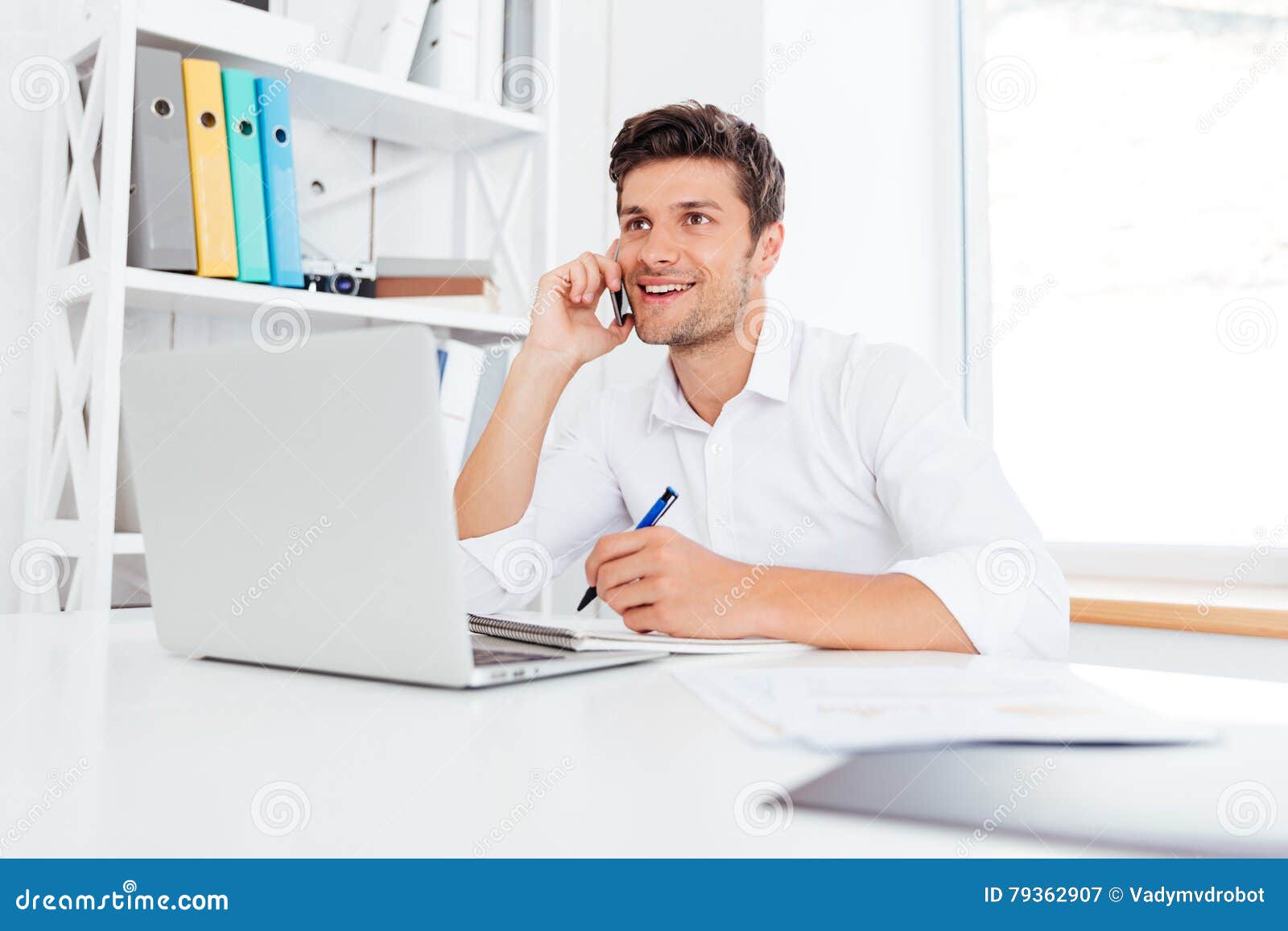Office Worker Calling on the Phone and Using Laptop Stock Image - Image ...