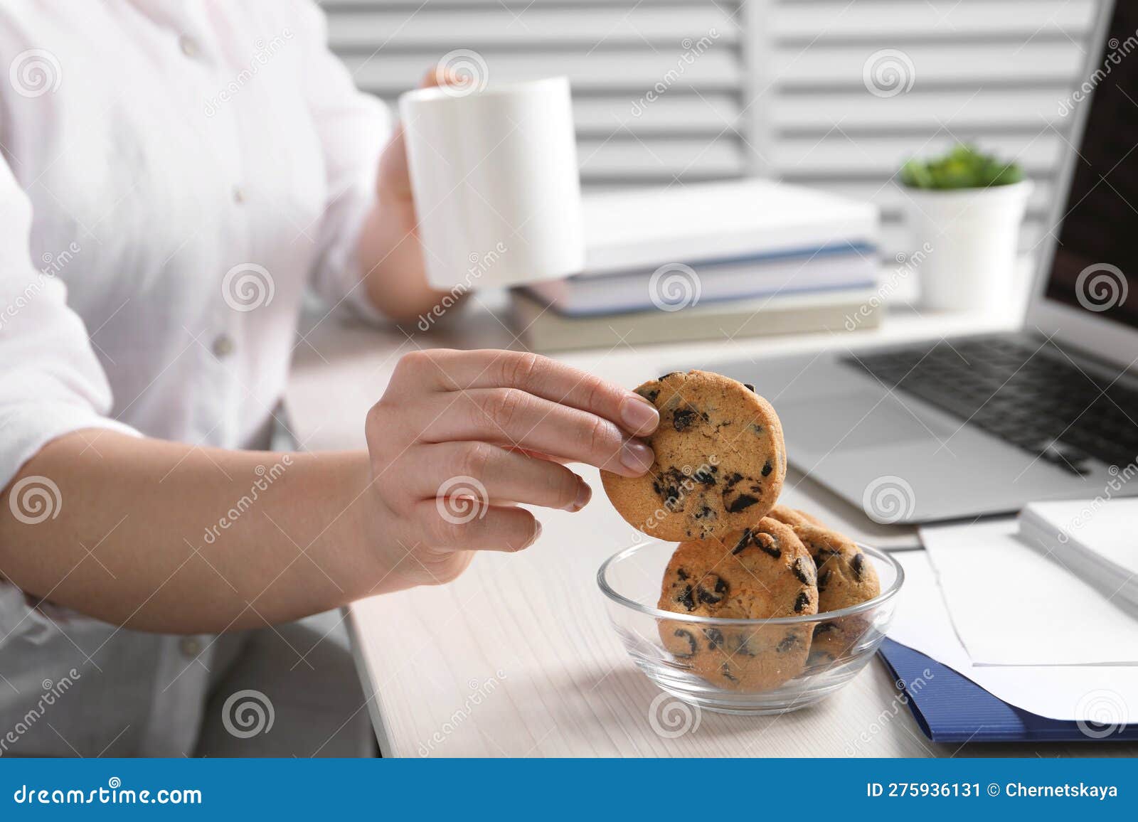 Office Worker with Cup of Drink Taking Chocolate Chip Cookie from Bowl ...