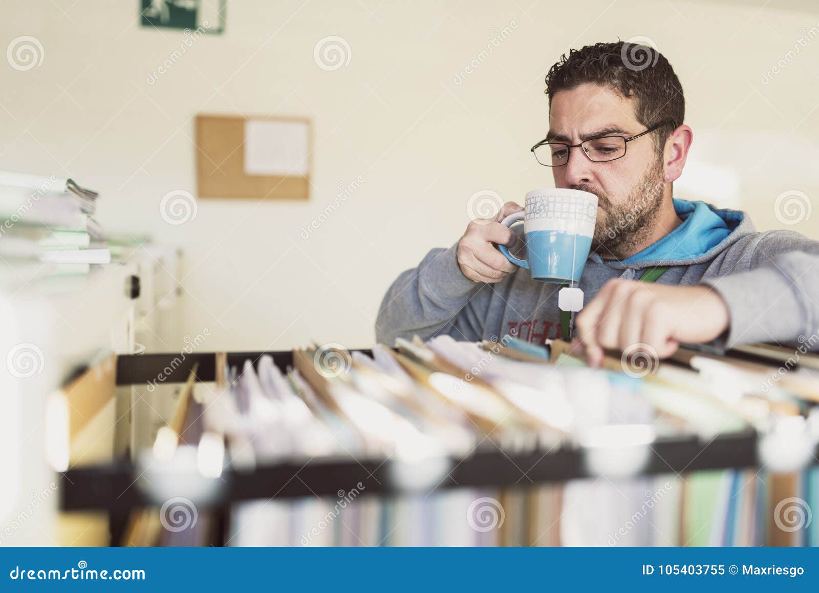 Office Worker Drinking Tea while Looking Files at Work Stock Image ...