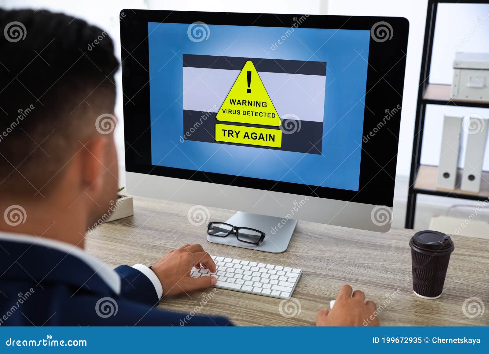 Office Worker in Front of Computer with Warning about Virus Attack on ...