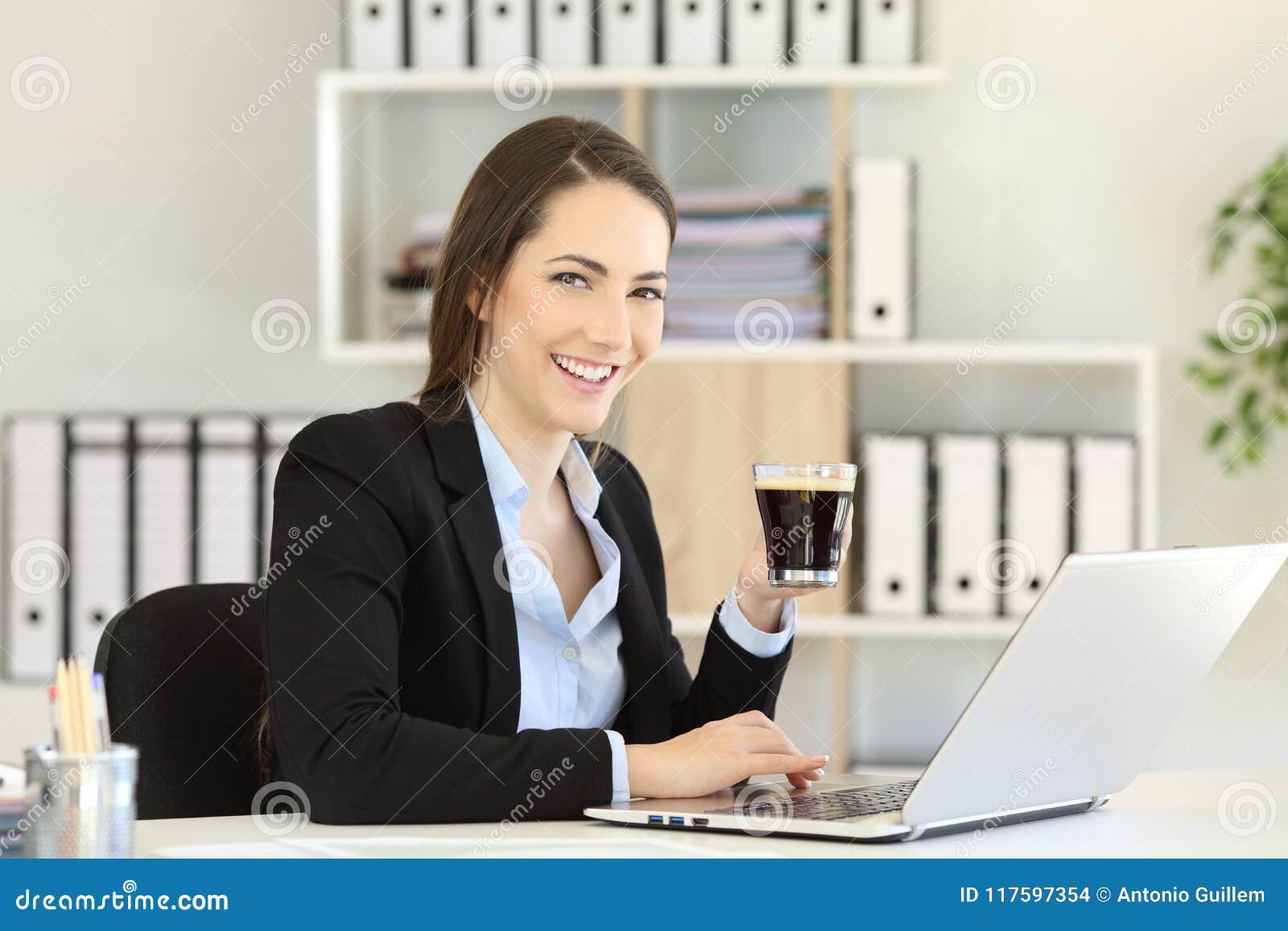 Office Worker Holding a Coffee Cup Looking at Camera Stock Photo ...