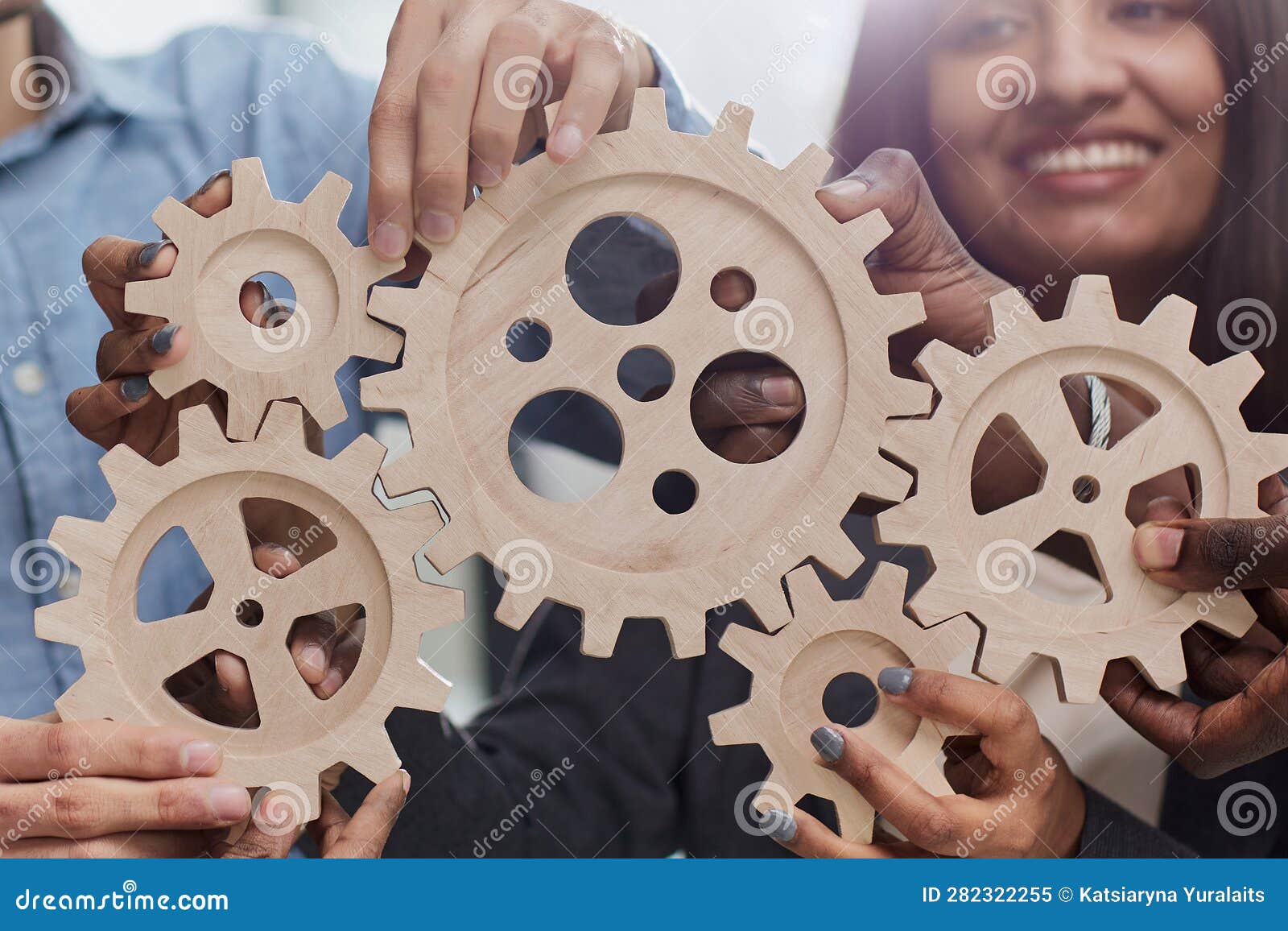 Office Worker Holding Cog Wheel As Unity and Teamwork in Corporate ...