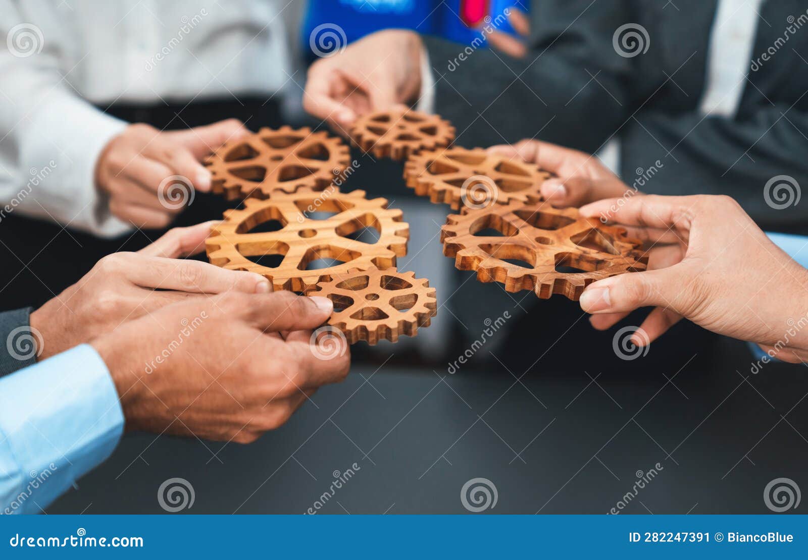 Office Worker Holding Cog Wheel As Unity and Teamwork in Workplace ...