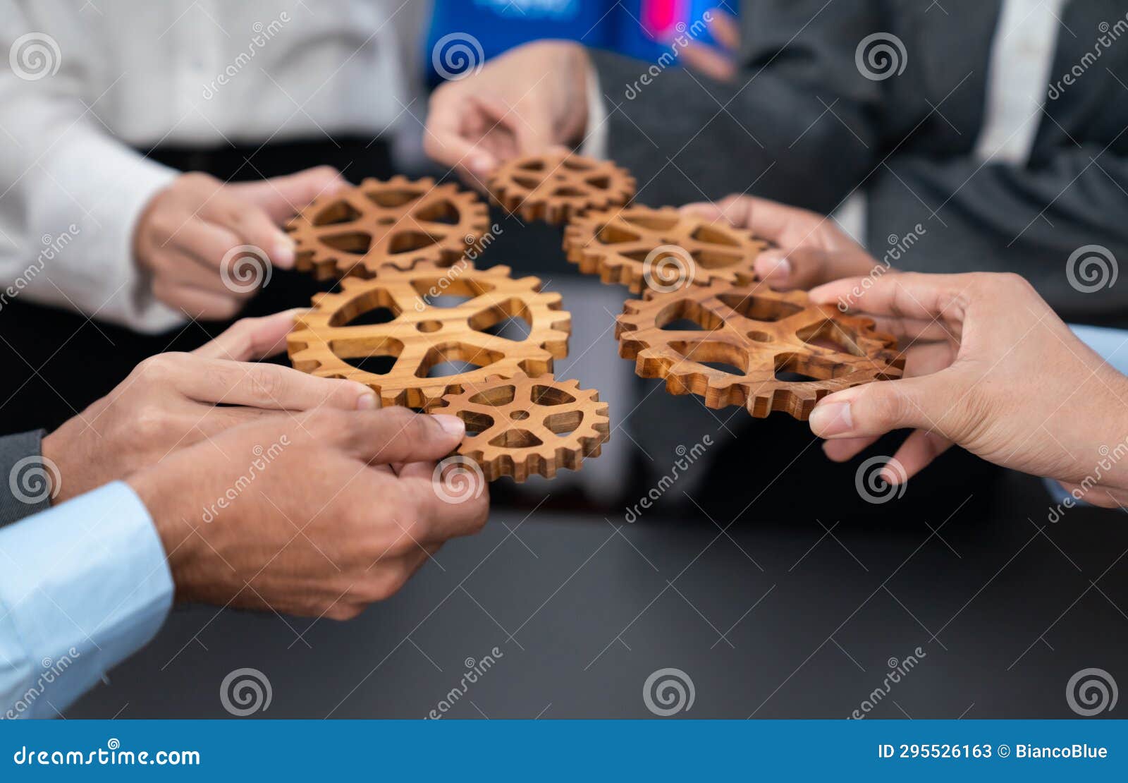 Office Worker Holding Cog Wheel As Unity and Teamwork in Workplace ...