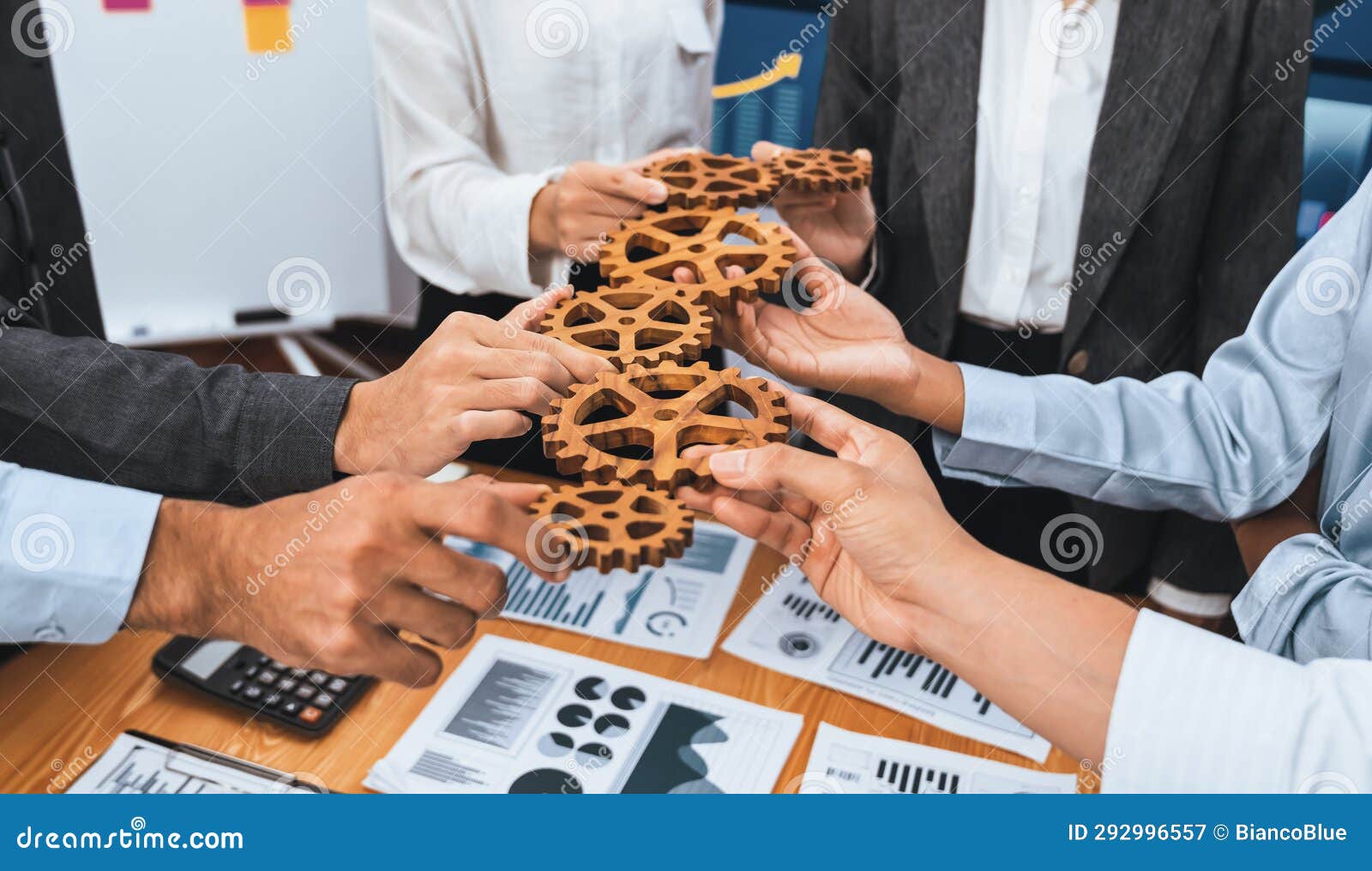 Office Worker Holding Cog Wheel As Unity and Teamwork in Workplace ...