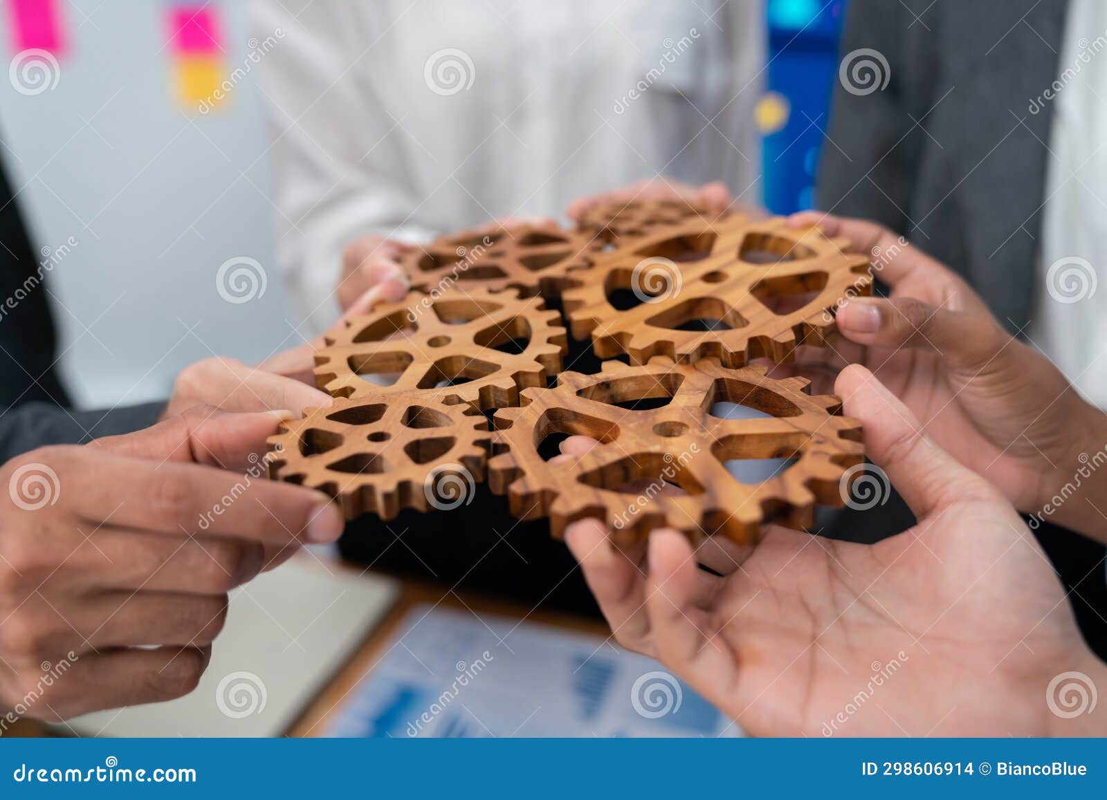 Office Worker Holding Cog Wheel As Unity and Teamwork in Workplace ...
