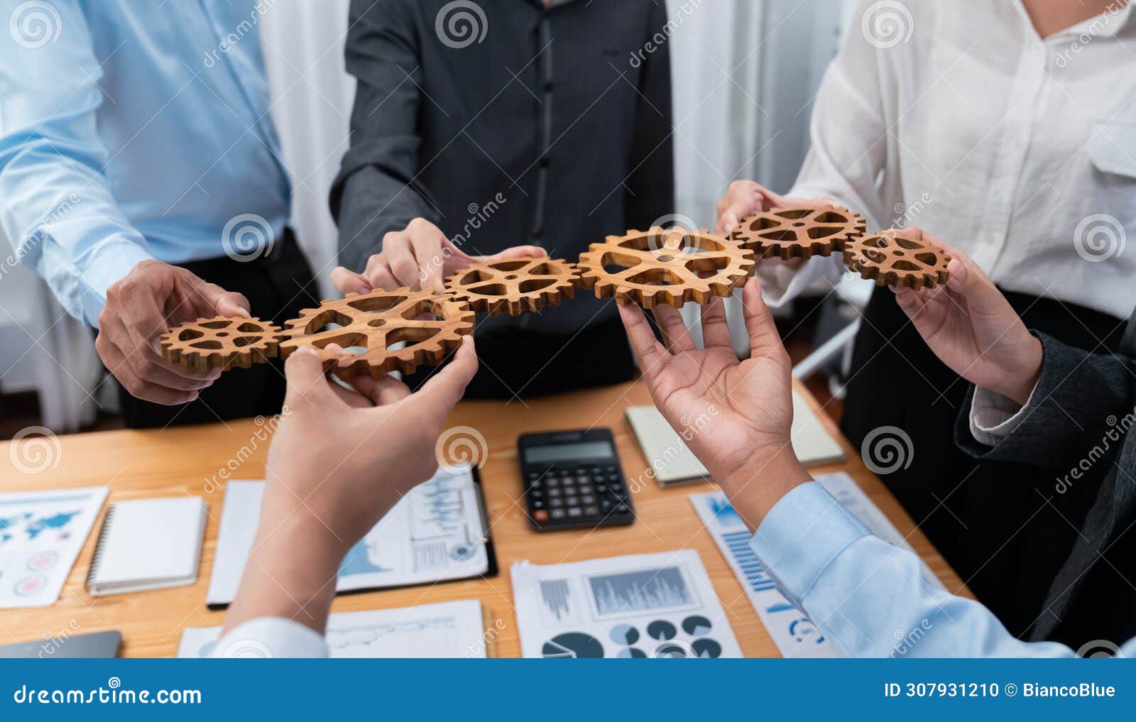 Office Worker Holding Cog Wheel As Unity and Teamwork in Workplace ...