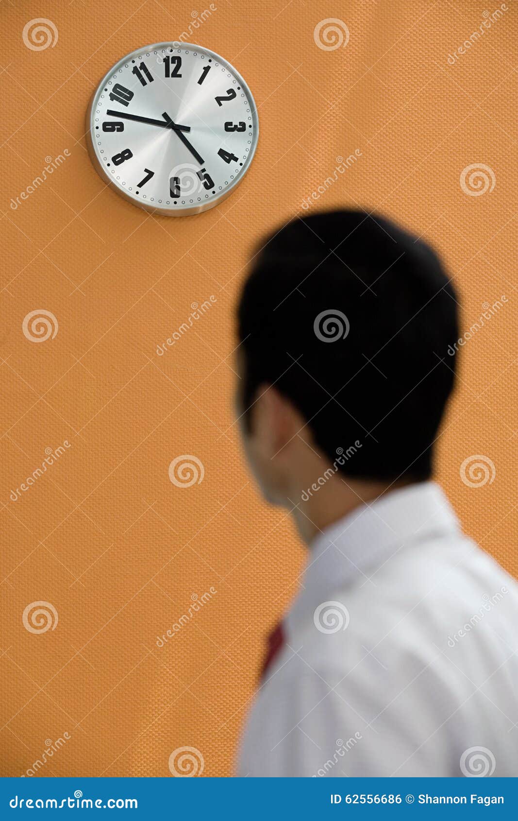 Office Worker Looking at a Wall Clock Stock Photo - Image of bored ...