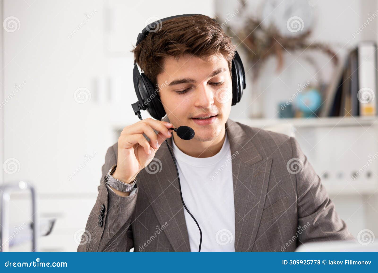 Office Worker Man is Working at Computer and Talking by Headset with ...