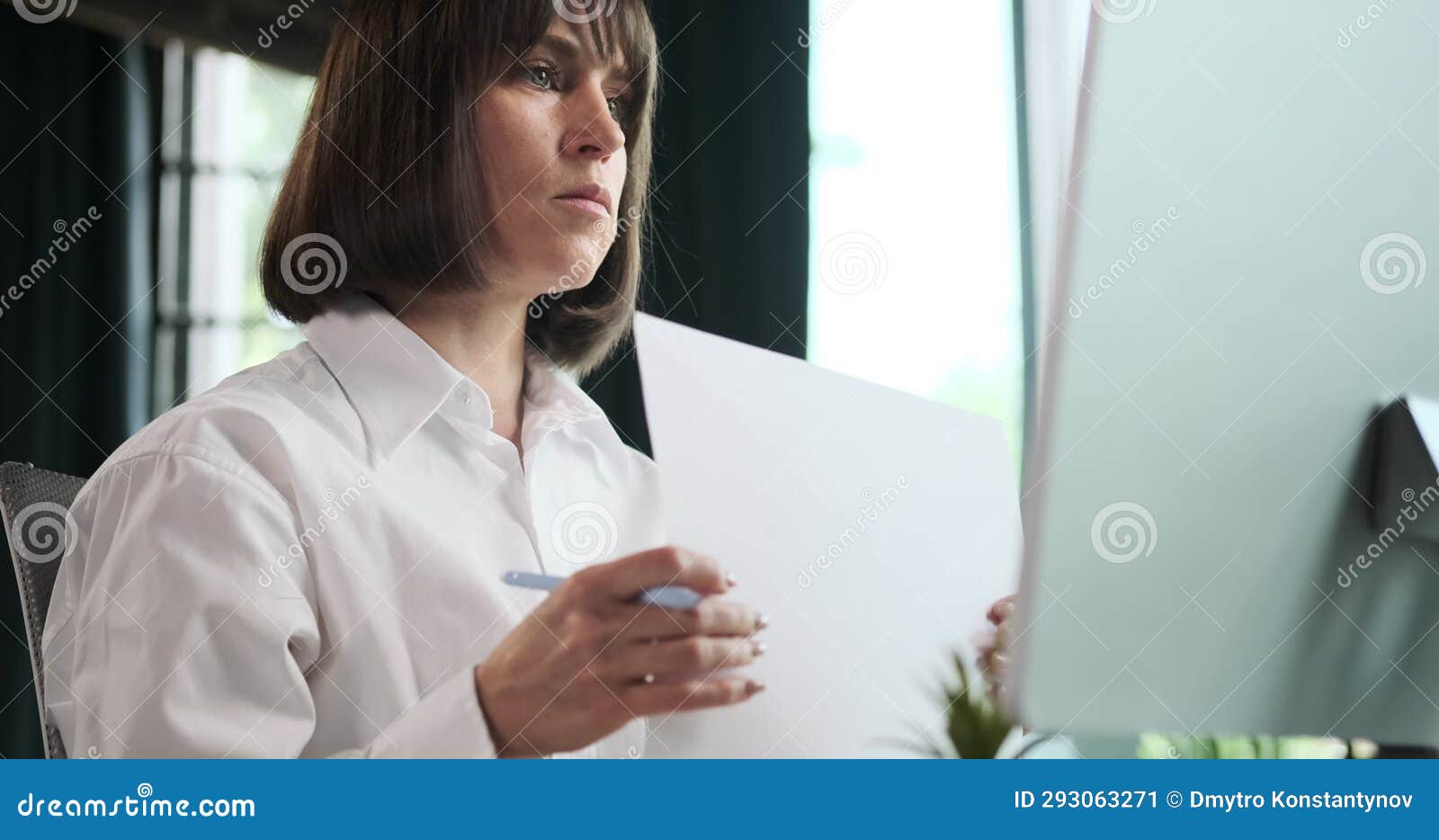Office Worker Cross Checking Documents with Computer Information in the ...