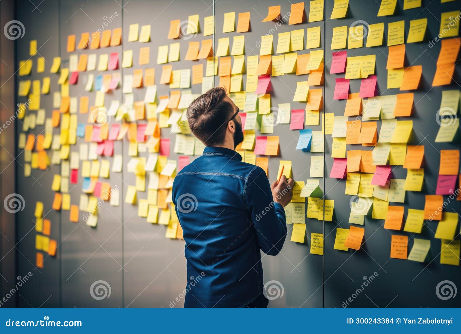 Office Worker Organizes Tasks with Sticky Notes on the Wall Stock ...