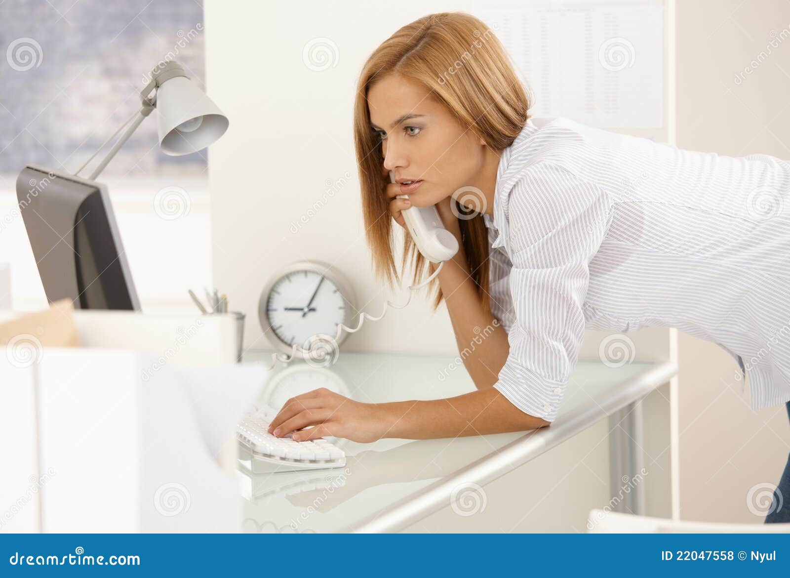Office Worker on Phone Using Computer Stock Photo - Image of attractive ...