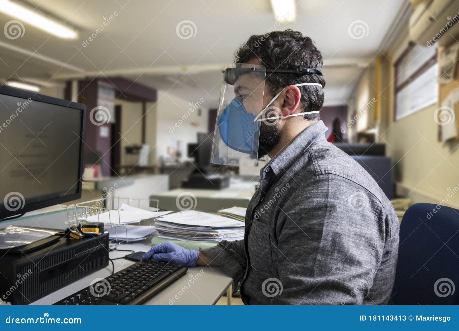 Office Worker with Plastic Protective Screen and Face Mask Working on ...