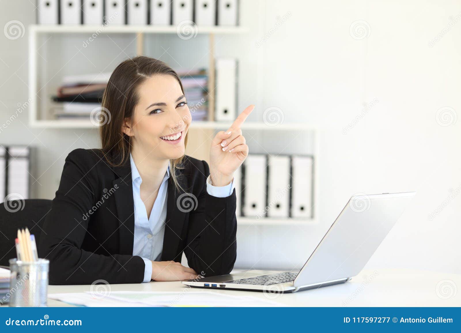 Office Worker Pointing at Side and Looking at Camera Stock Image ...
