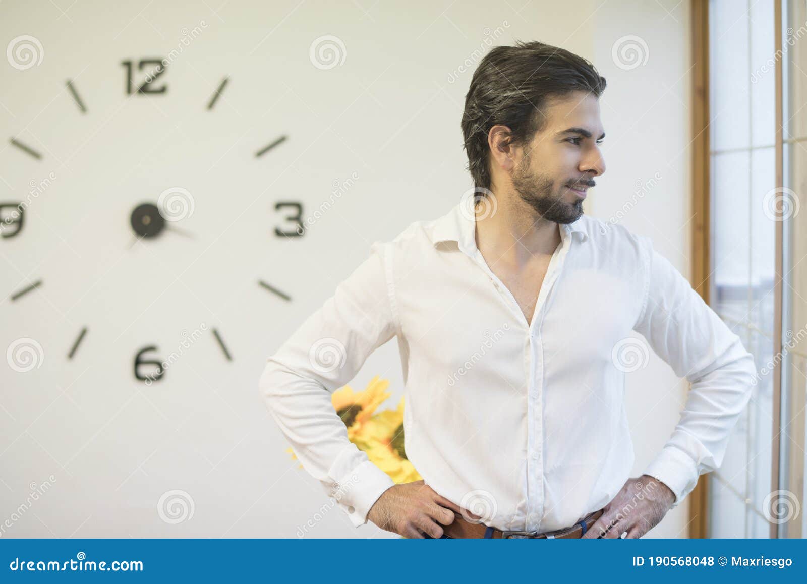Office Worker Poses Near a Clock Representing Punctuality Stock Photo ...