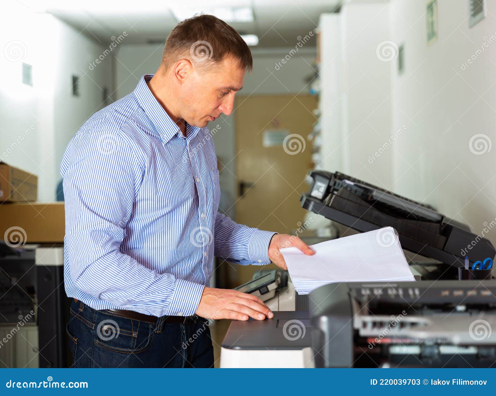 Office Worker Puts a Stack of Paper in the Printer Stock Image - Image ...