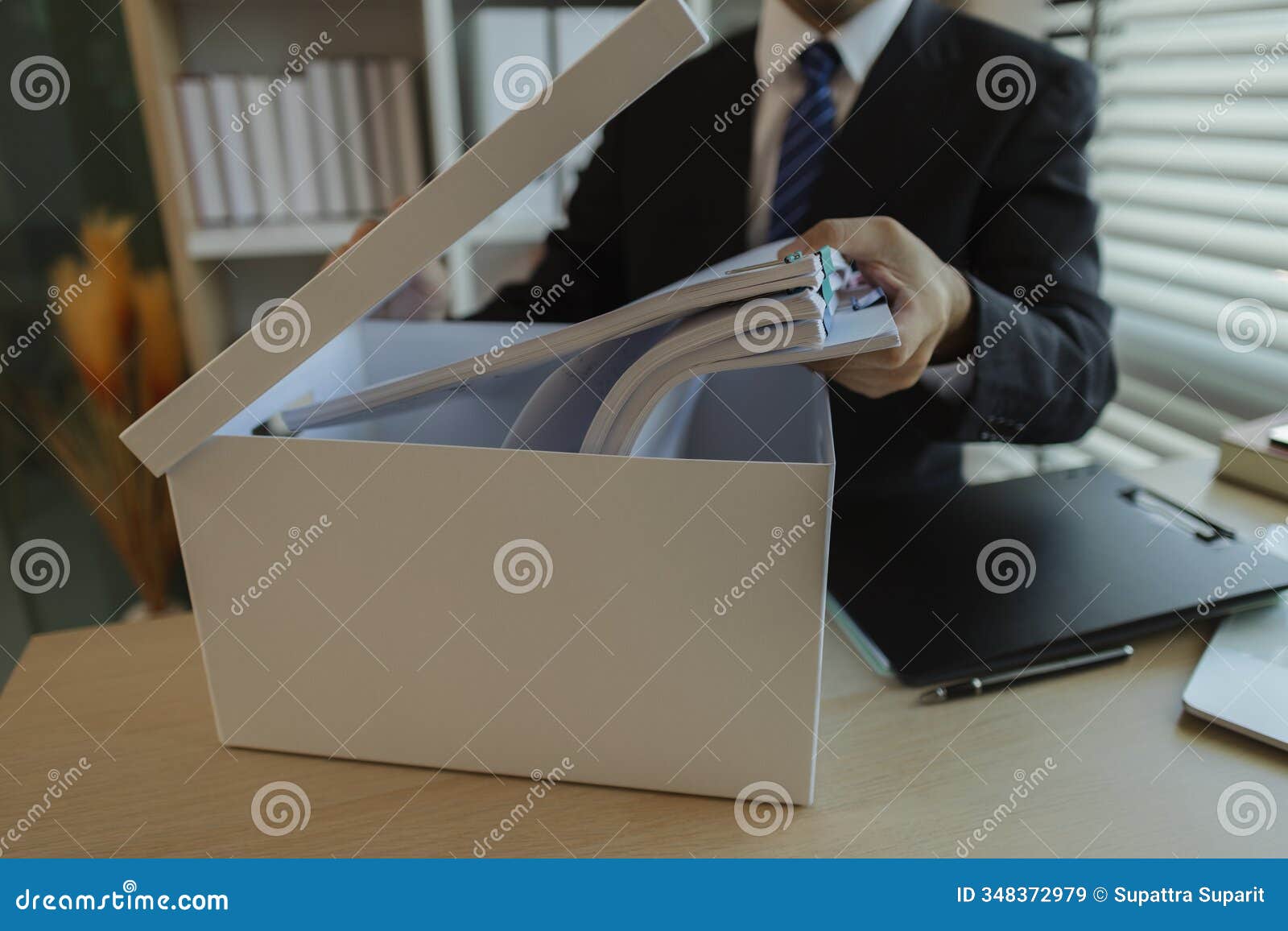 An Office Worker is Putting Important Documents in Boxes To Prevent ...