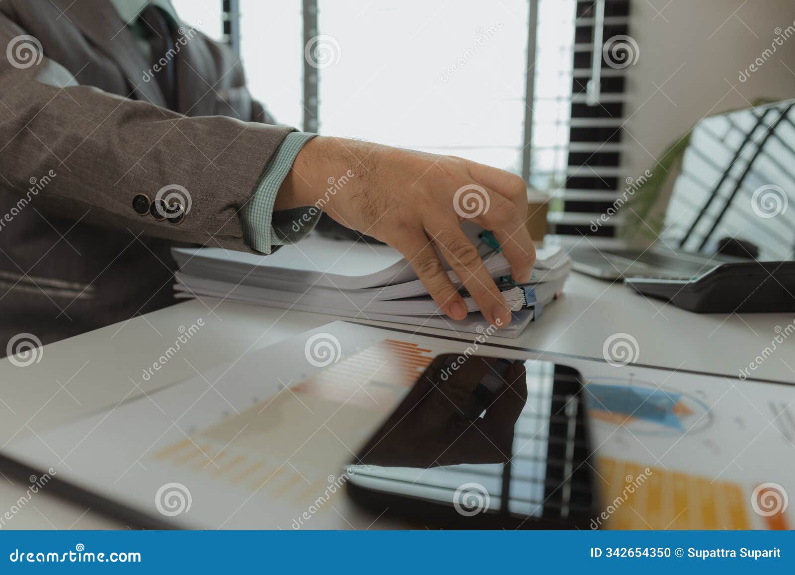 An Office Worker is Putting Important Documents Together To Keep ...