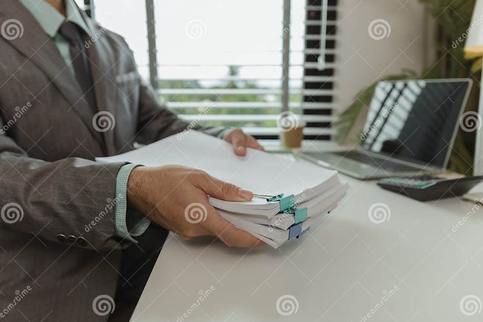 An Office Worker is Putting Important Documents Together To Keep ...