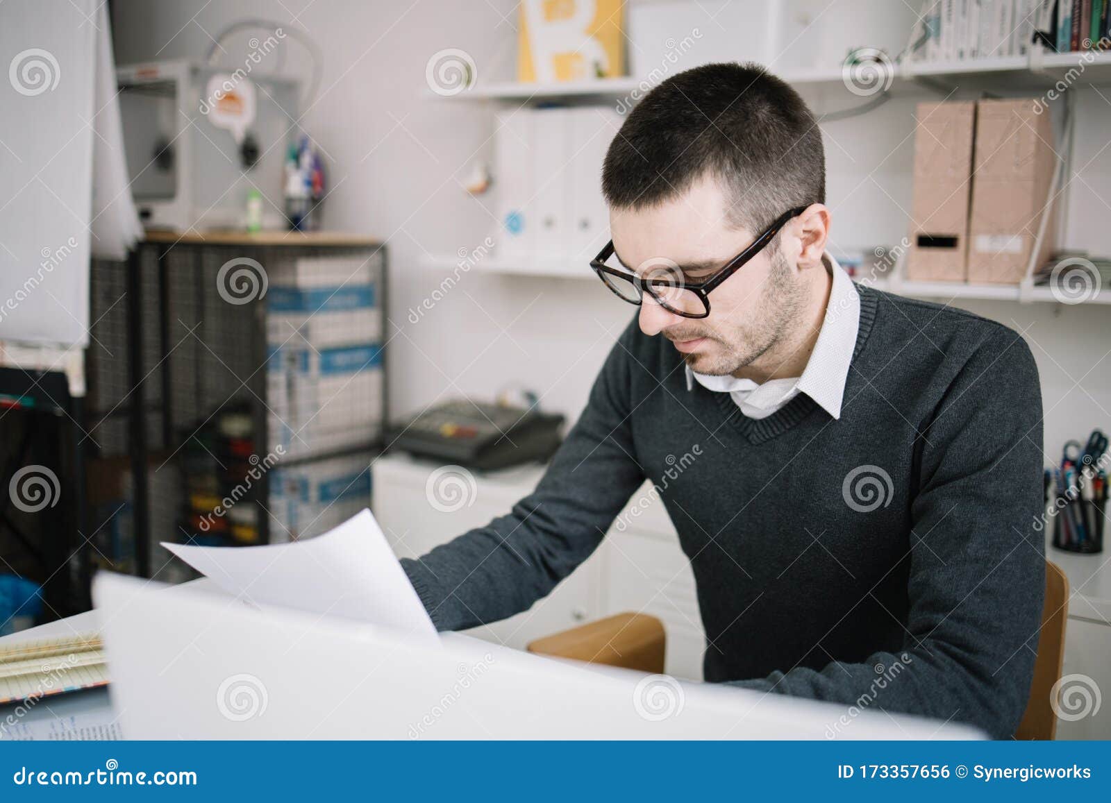 Office Worker Reading Paperwork in the Office Stock Photo - Image of ...