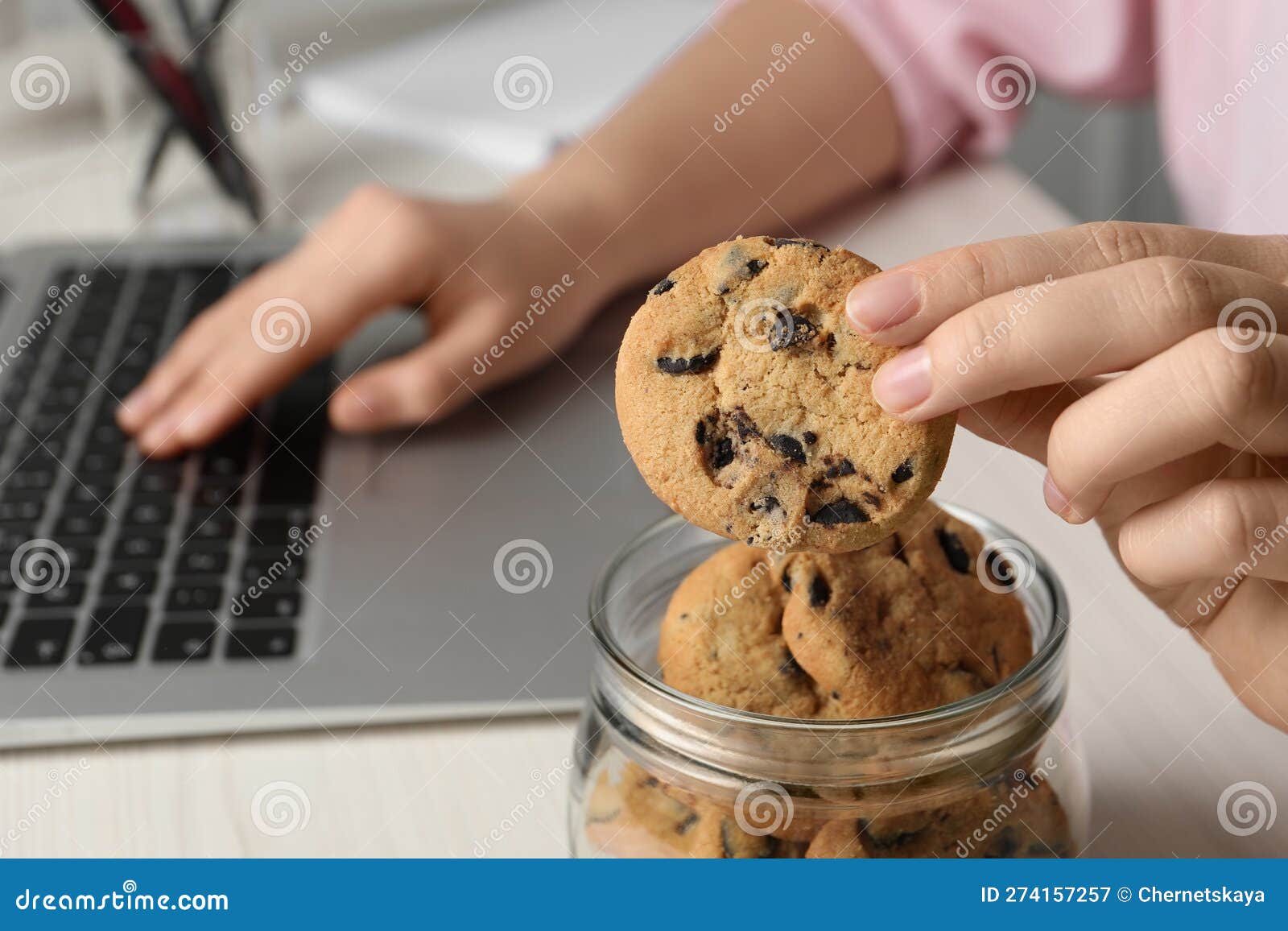 Office Worker Taking Chocolate Chip Cookie from Jar at Workplace ...