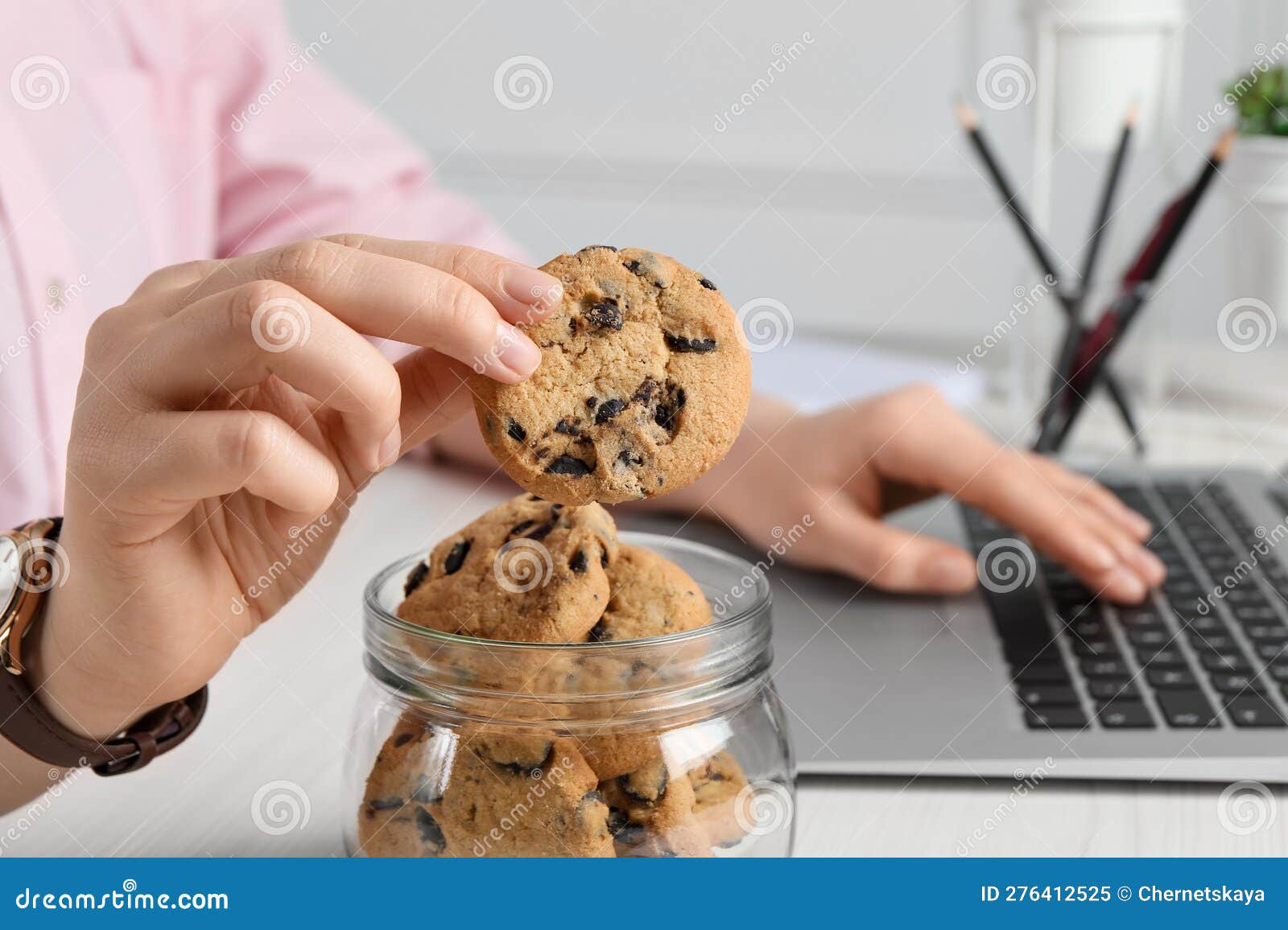 Office Worker Taking Chocolate Chip Cookie from Jar at Workplace ...
