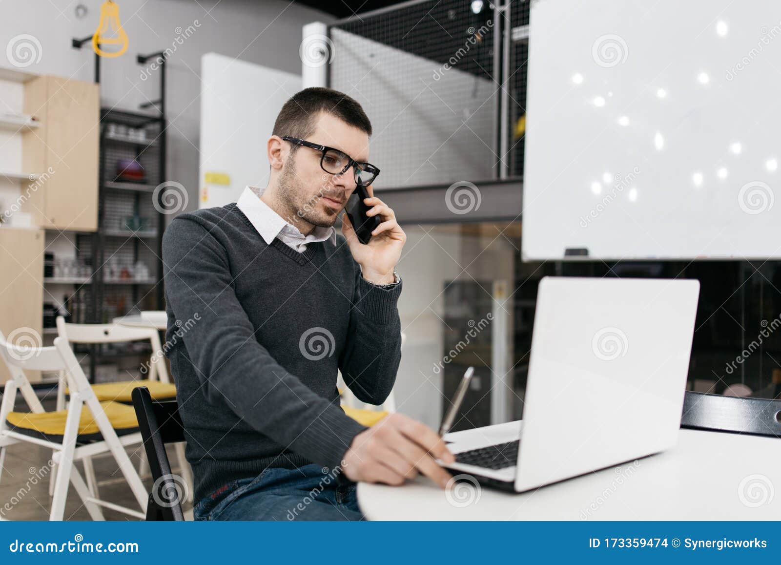 Office Worker Using Laptop while Talking on Phone Stock Photo - Image ...