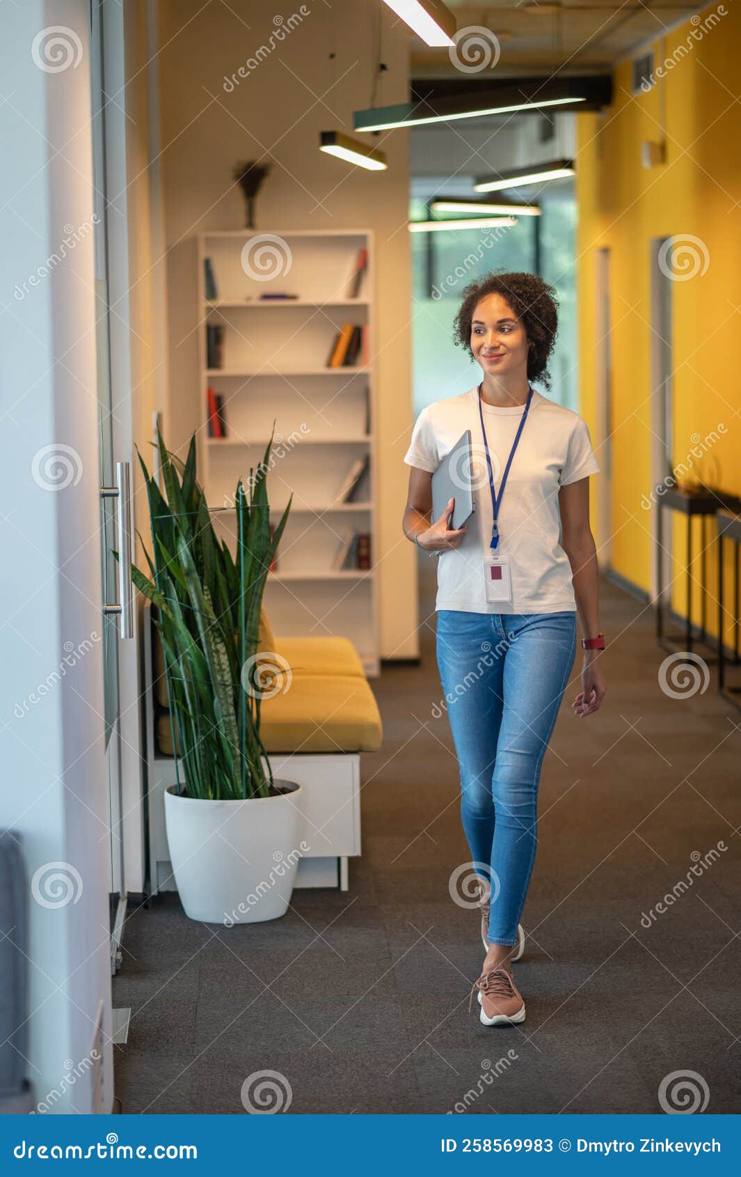 Office Worker Walking in the Office Corridor and Looking Contented ...