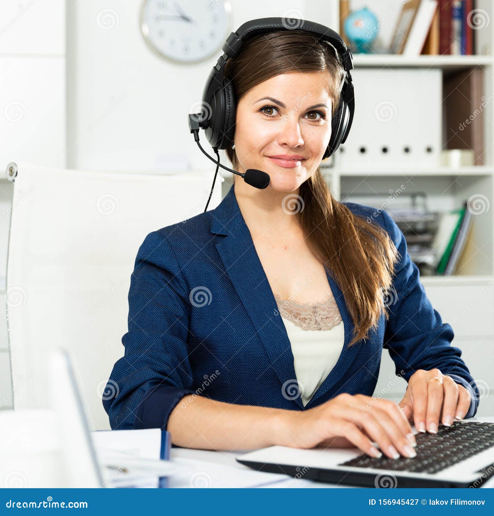 Worker Woman is Working at a Computer and Talking by Headset with ...