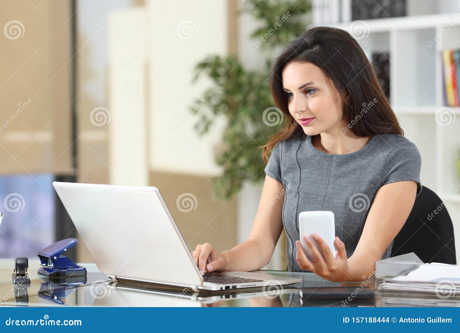 Office Worker Working on Line Using Phone and Laptop Stock Photo ...
