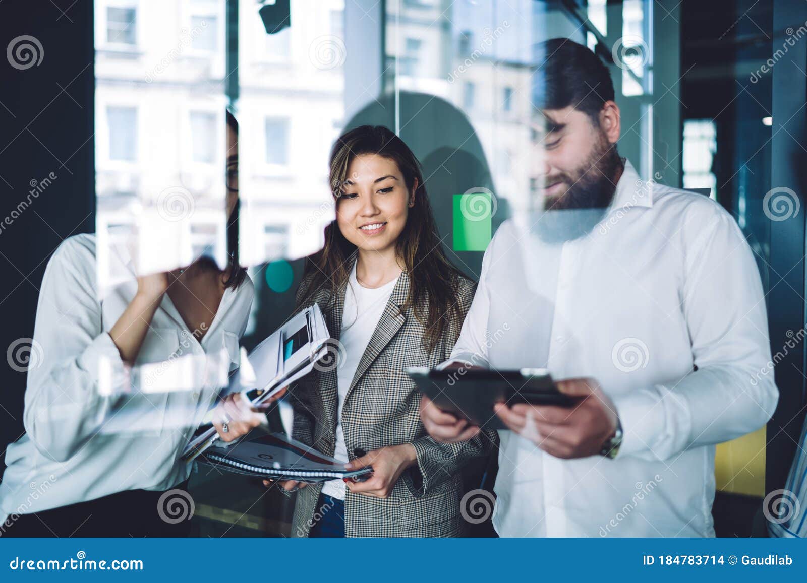 Office Workers Discussing Data on Tablet in Modern Office Stock Photo ...