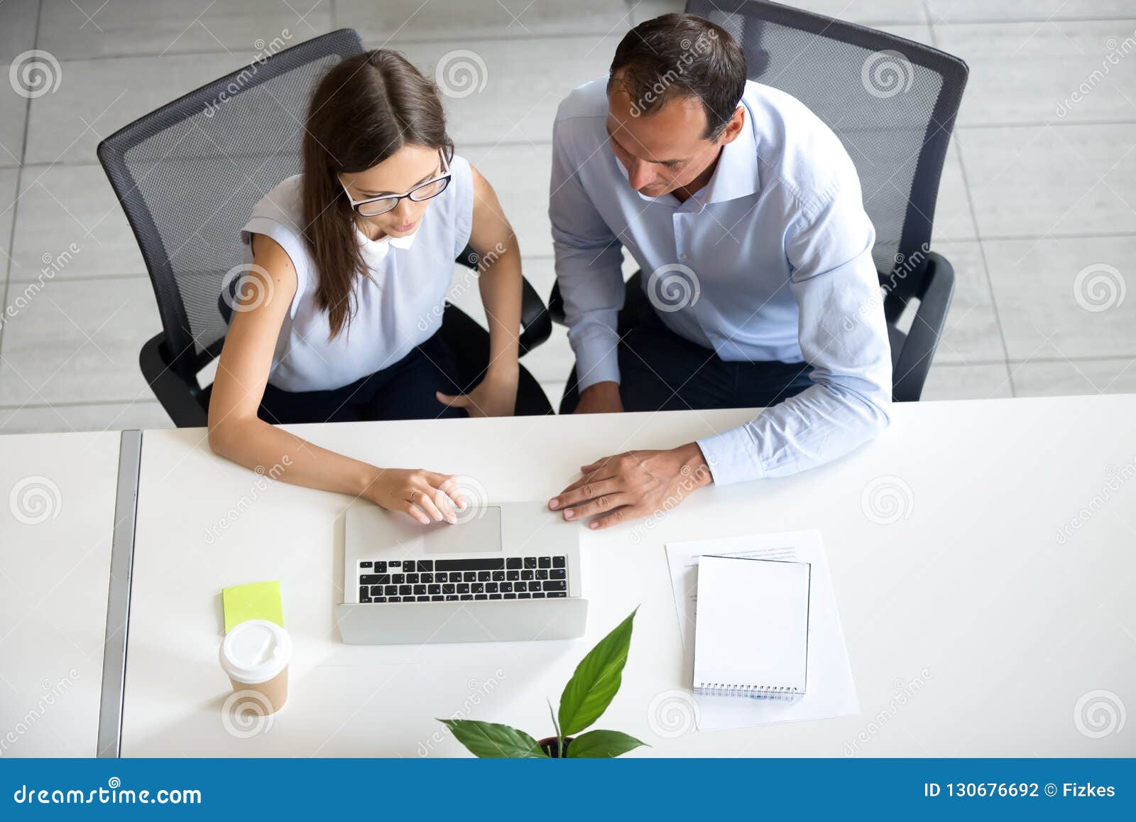Office Workers Discussing Project Working Together Using Laptop, Stock ...