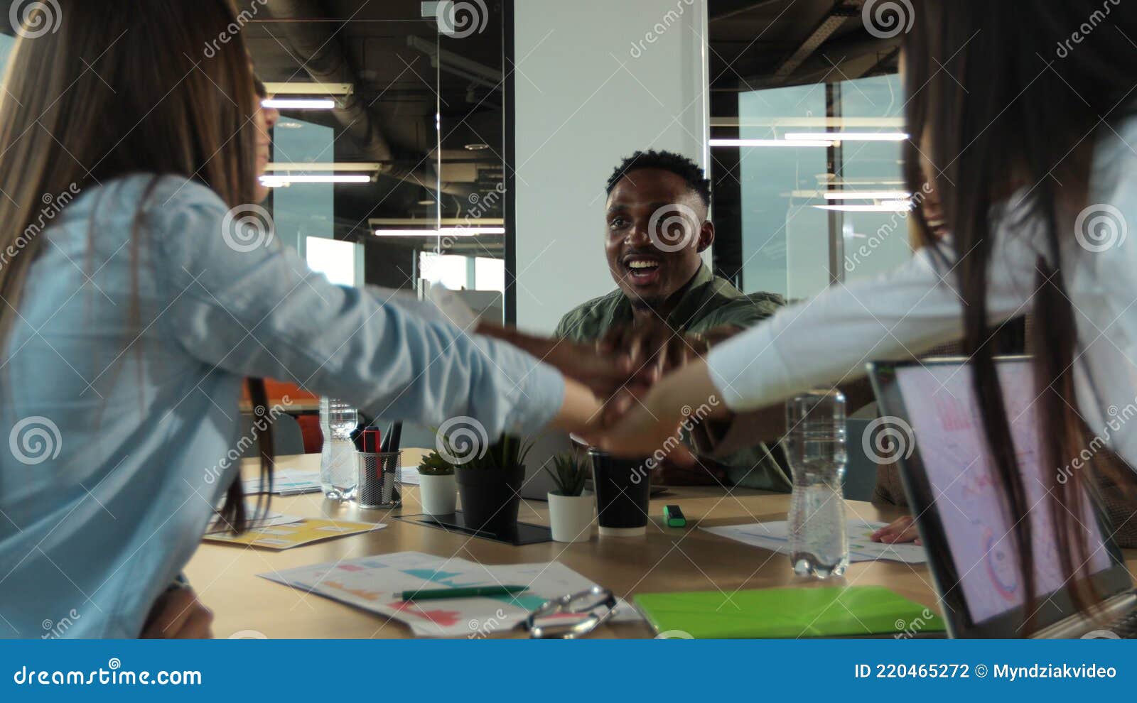Office Workers Doing Team Building Exercise Stacking Hands Together in ...