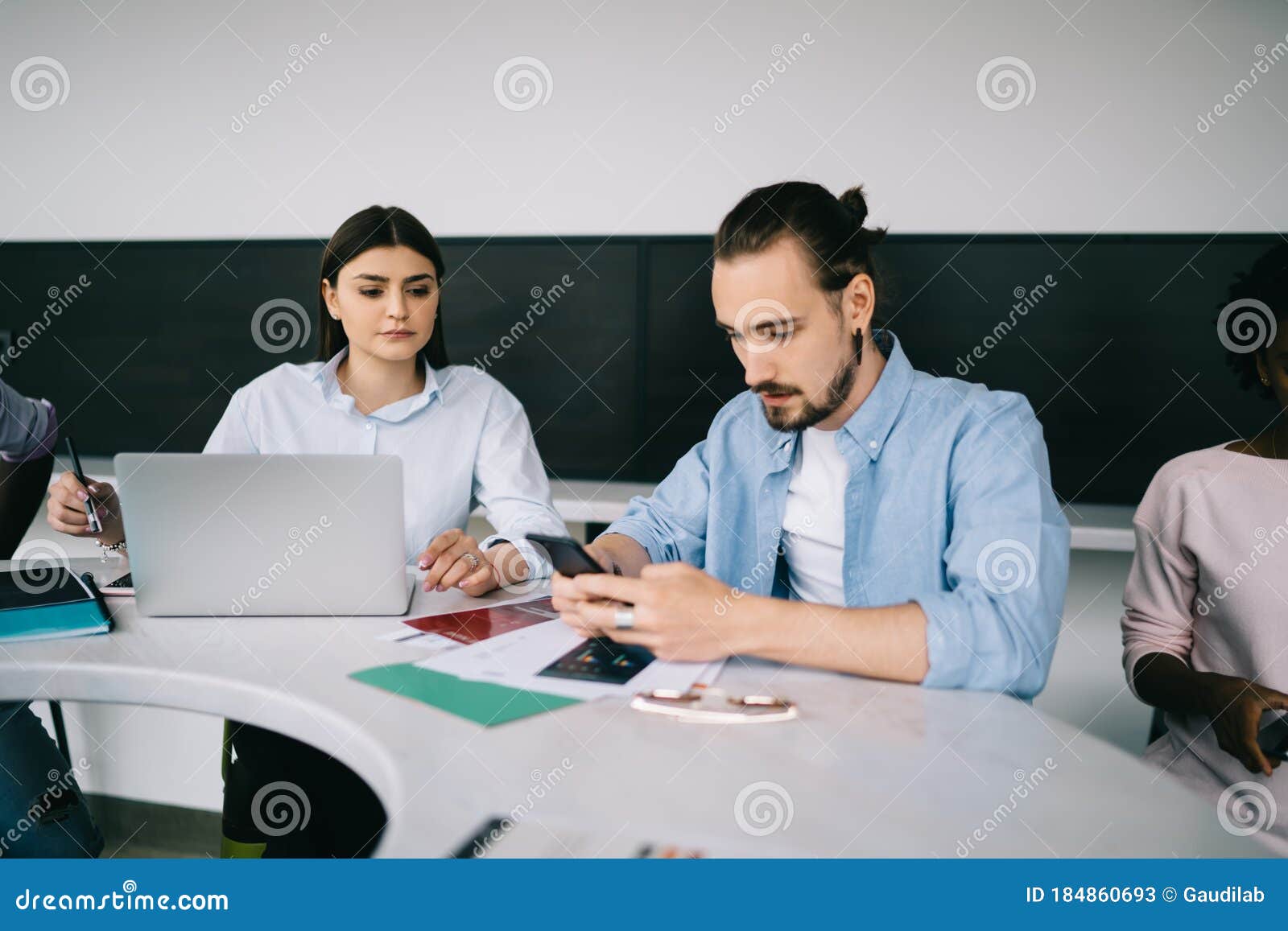 Office Workers Using Gadgets while Working Together at Project Stock ...