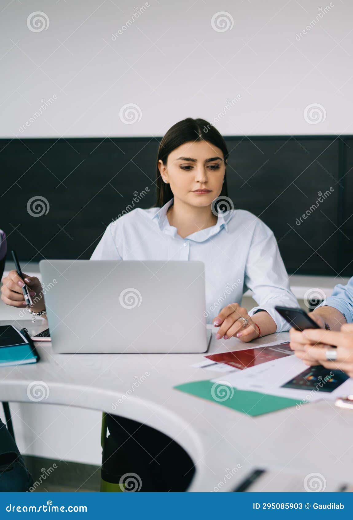 Office Workers Using Gadgets while Working Together at Project Stock ...