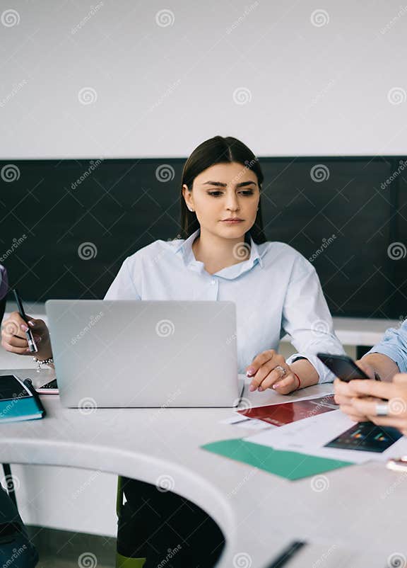 Office Workers Using Gadgets while Working Together at Project Stock ...