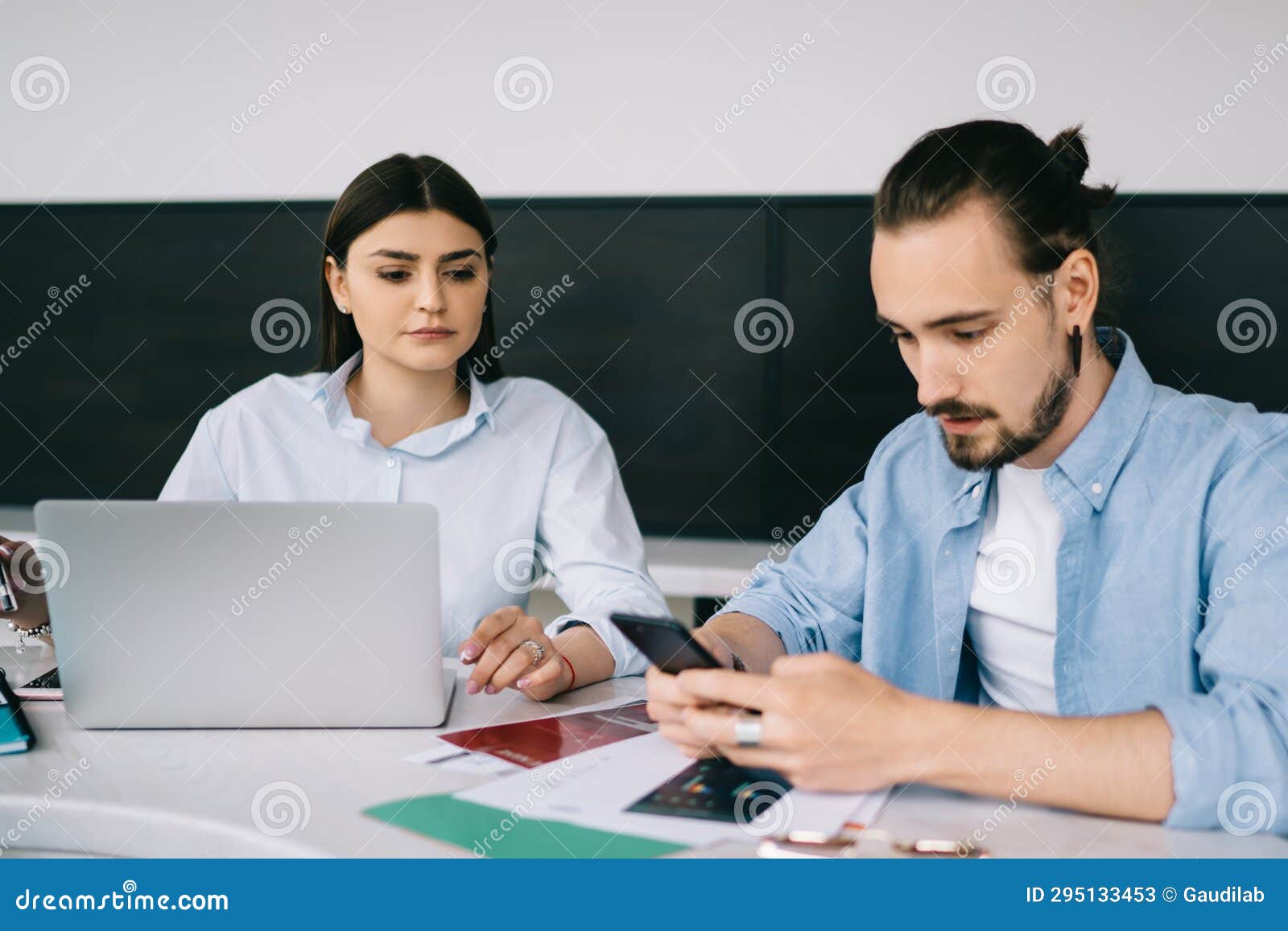 Office Workers Using Gadgets while Working Together at Project Stock ...