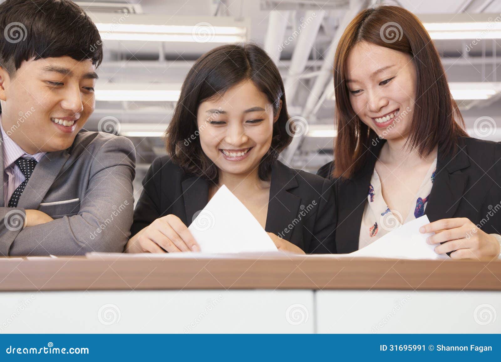 Office Workers Working Together, Looking at Documents Stock Image ...