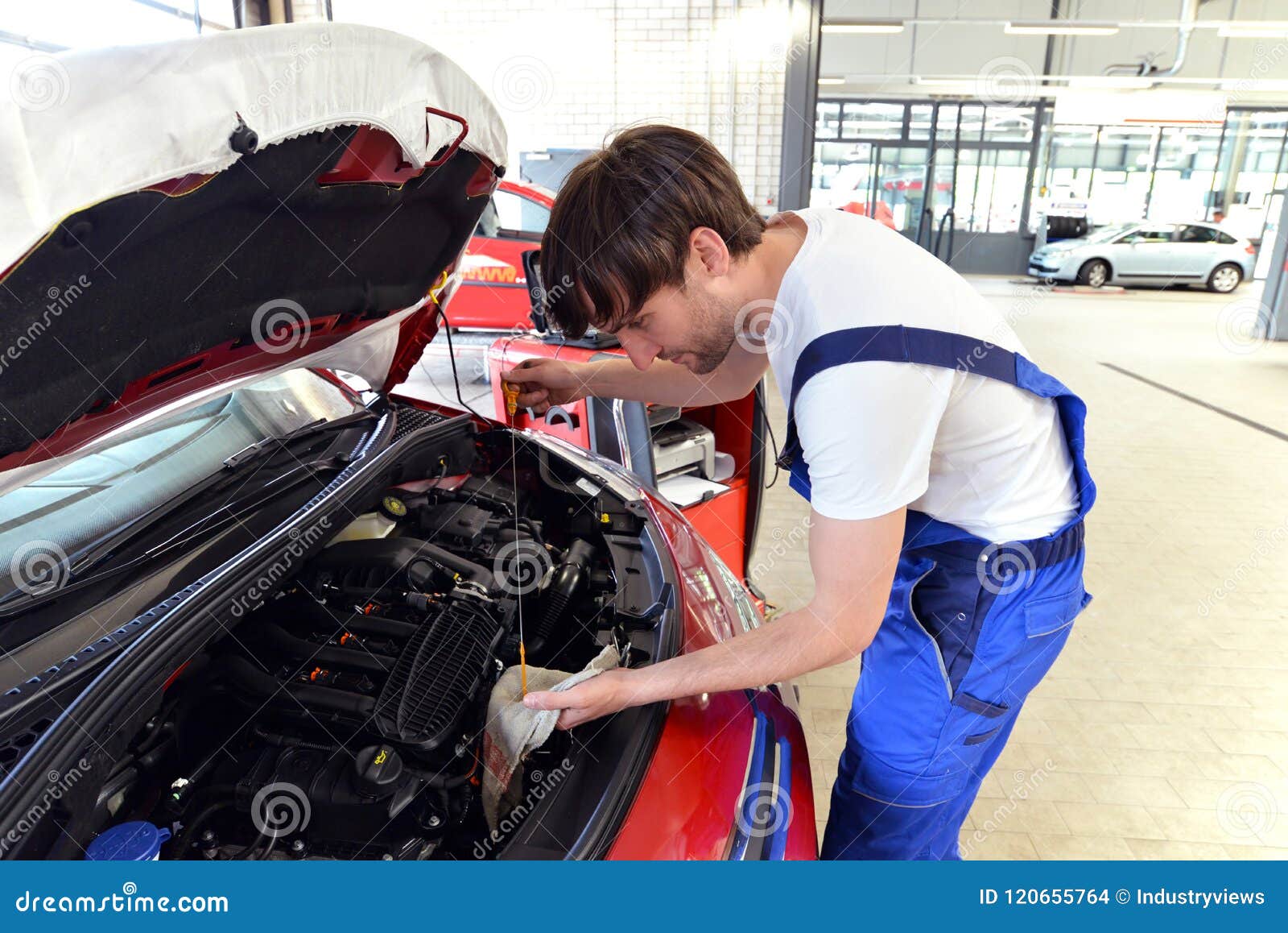 Professional Mechanic In Uniform Is Check The Quality Of New Car Before ...