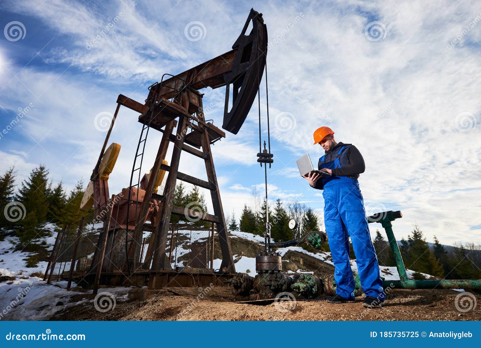 Oil Man with Laptop Controlling Work of Pump Jack. Stock Image - Image ...
