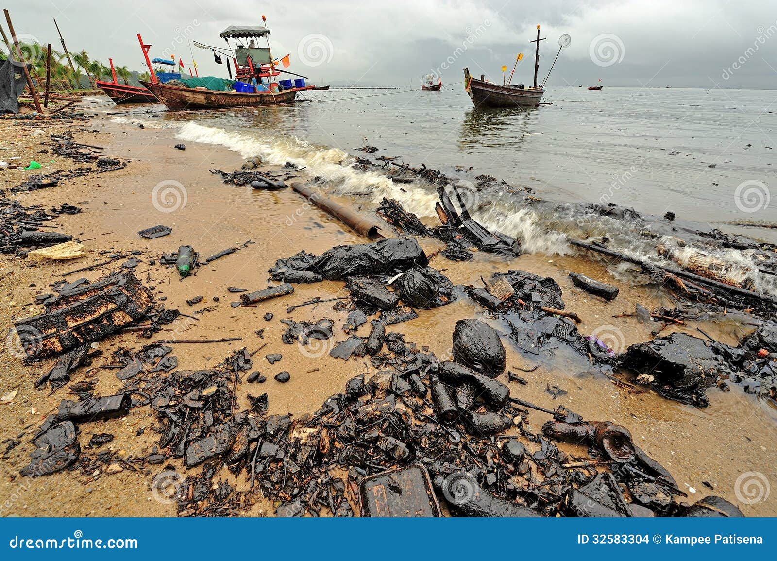 Oil polution on the beach stock photo. Image of escape - 32583304