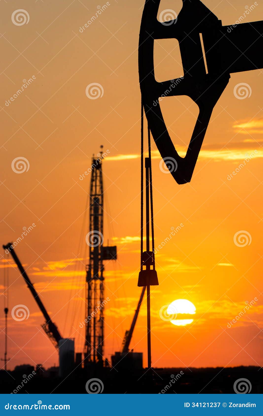 Oil rig over orange sky stock image. Image of construction - 34121237